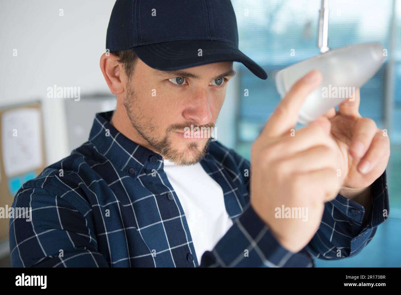 young electrical engineers installing a lamp Stock Photo - Alamy