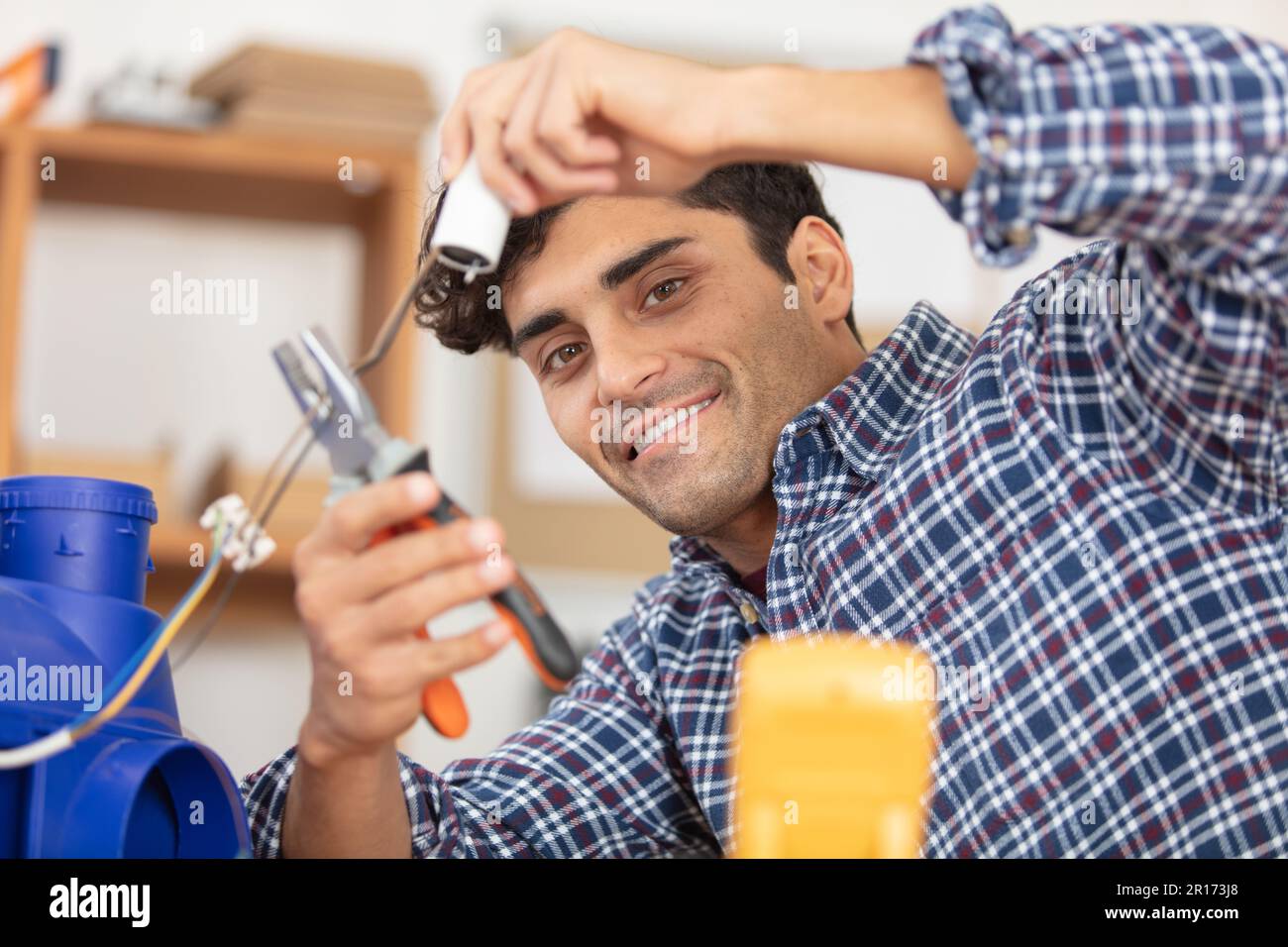male electrician at work laying wiring cable Stock Photo - Alamy