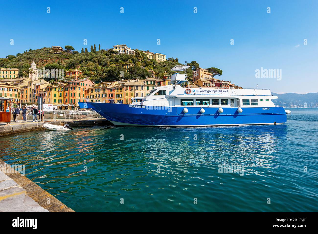Ferry with many tourists in the famous village of Portofino, luxury ...