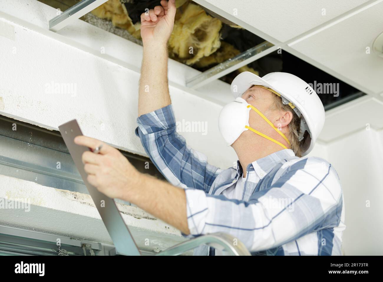 man working on ceiling cables Stock Photo - Alamy