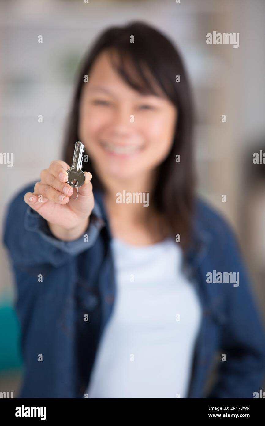 young asian woman showing a key Stock Photo - Alamy