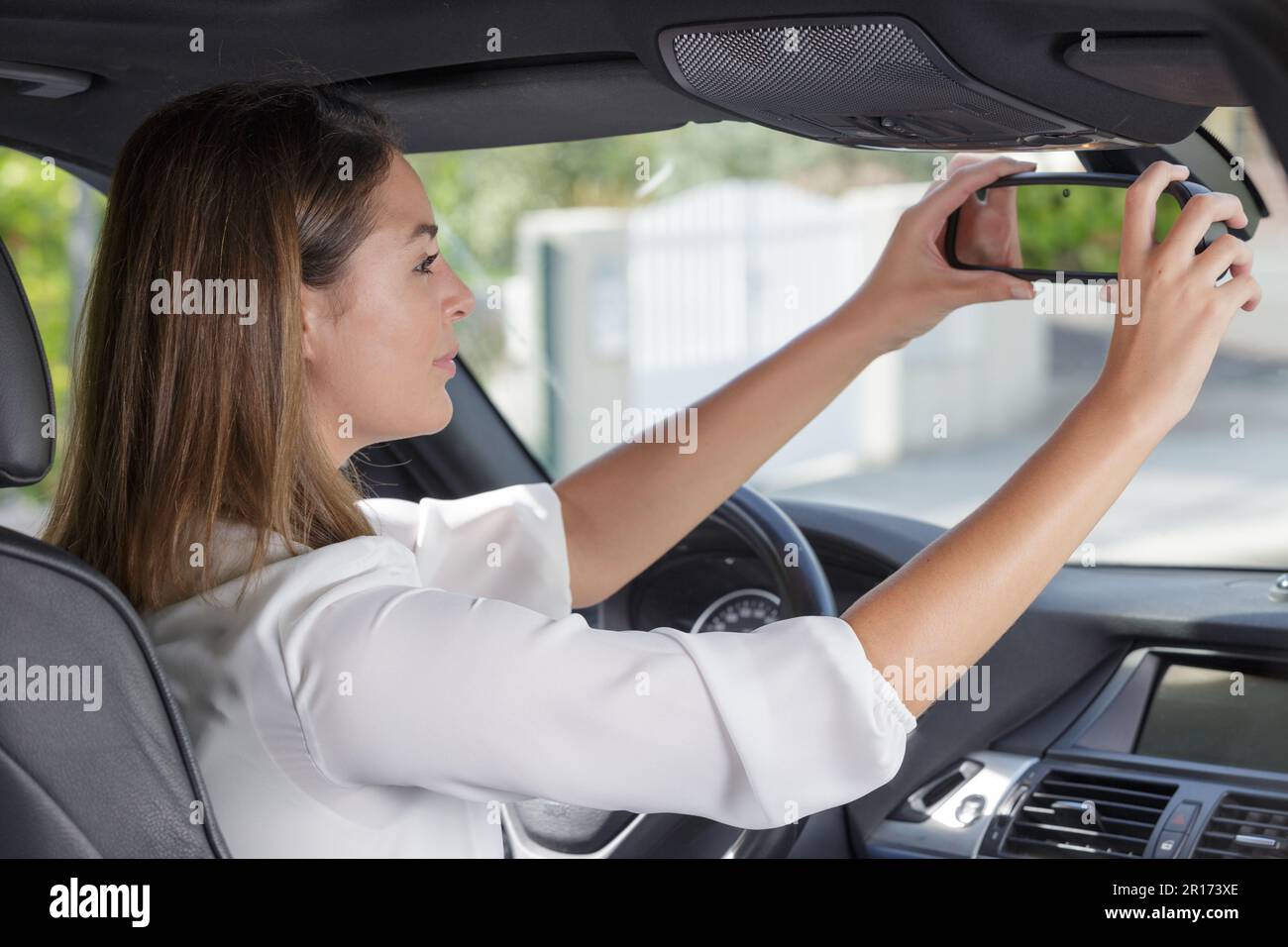 woman adjusting rear view mirror Stock Photo - Alamy