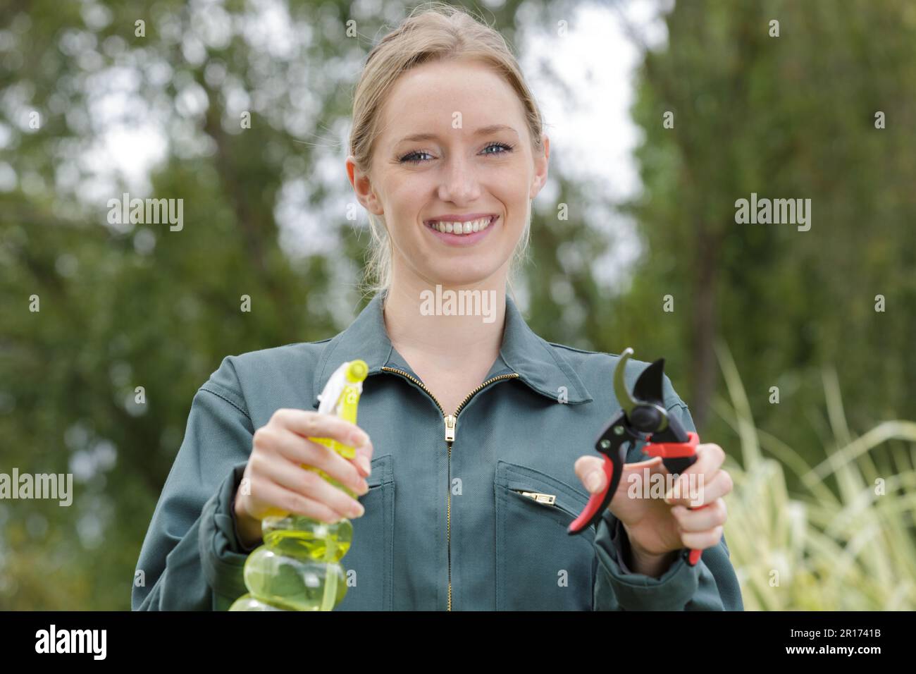 beautiful gardener taking care of plants Stock Photo - Alamy