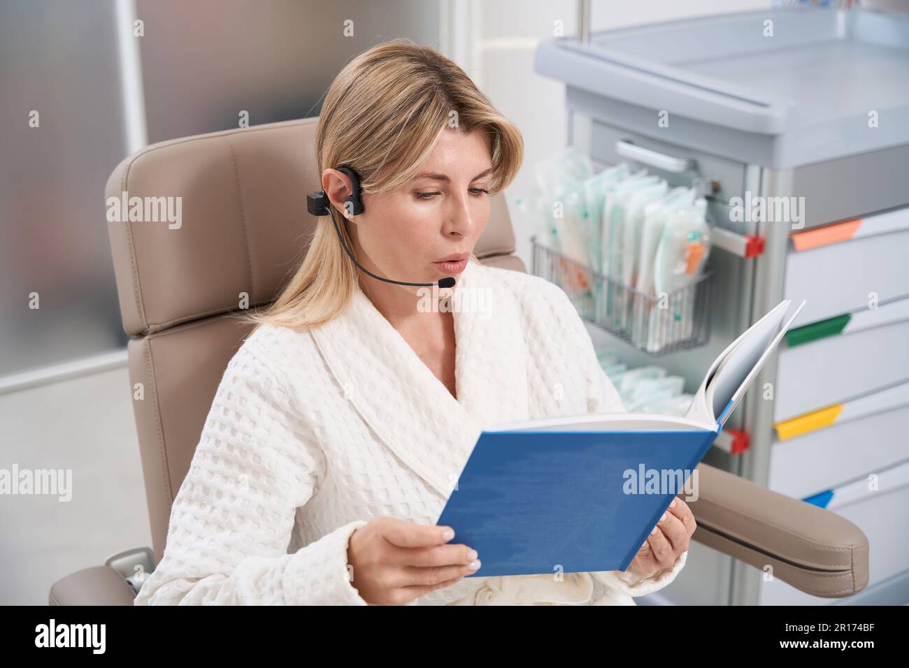 Female patient on modern voice staging procedure with forbrein headset ...