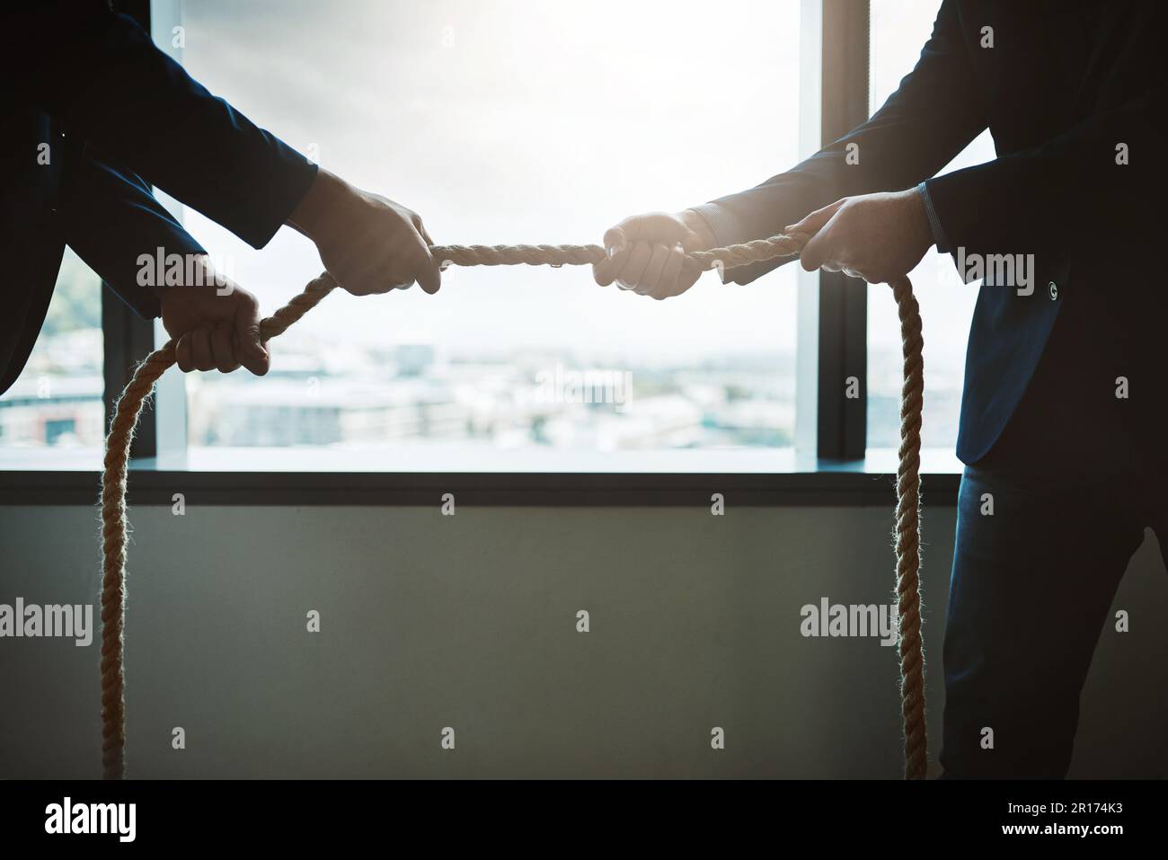 The battle of the business greats. two businessmen pulling on a rope in ...