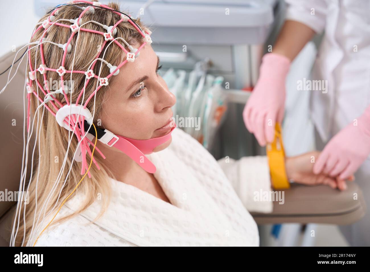 Diagnostician prepares the patient for electroencephalogram procedure ...