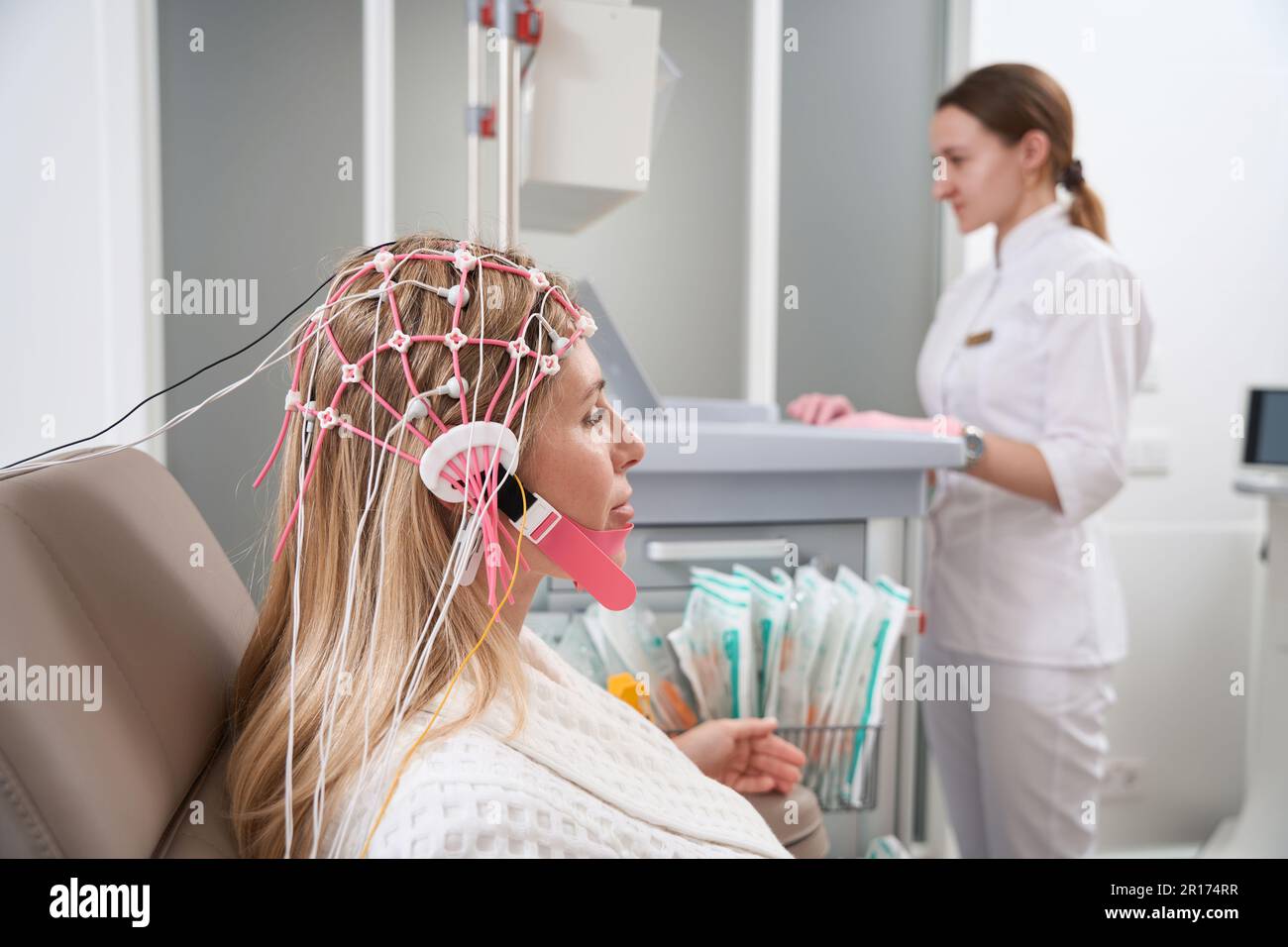 Diagnostician conducts electroencephalogram procedure young female ...