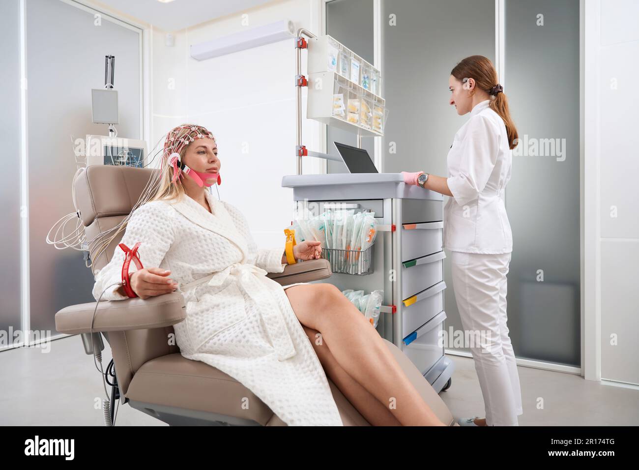 Female patient in rehabilitation center undergoes electroencephalogram ...