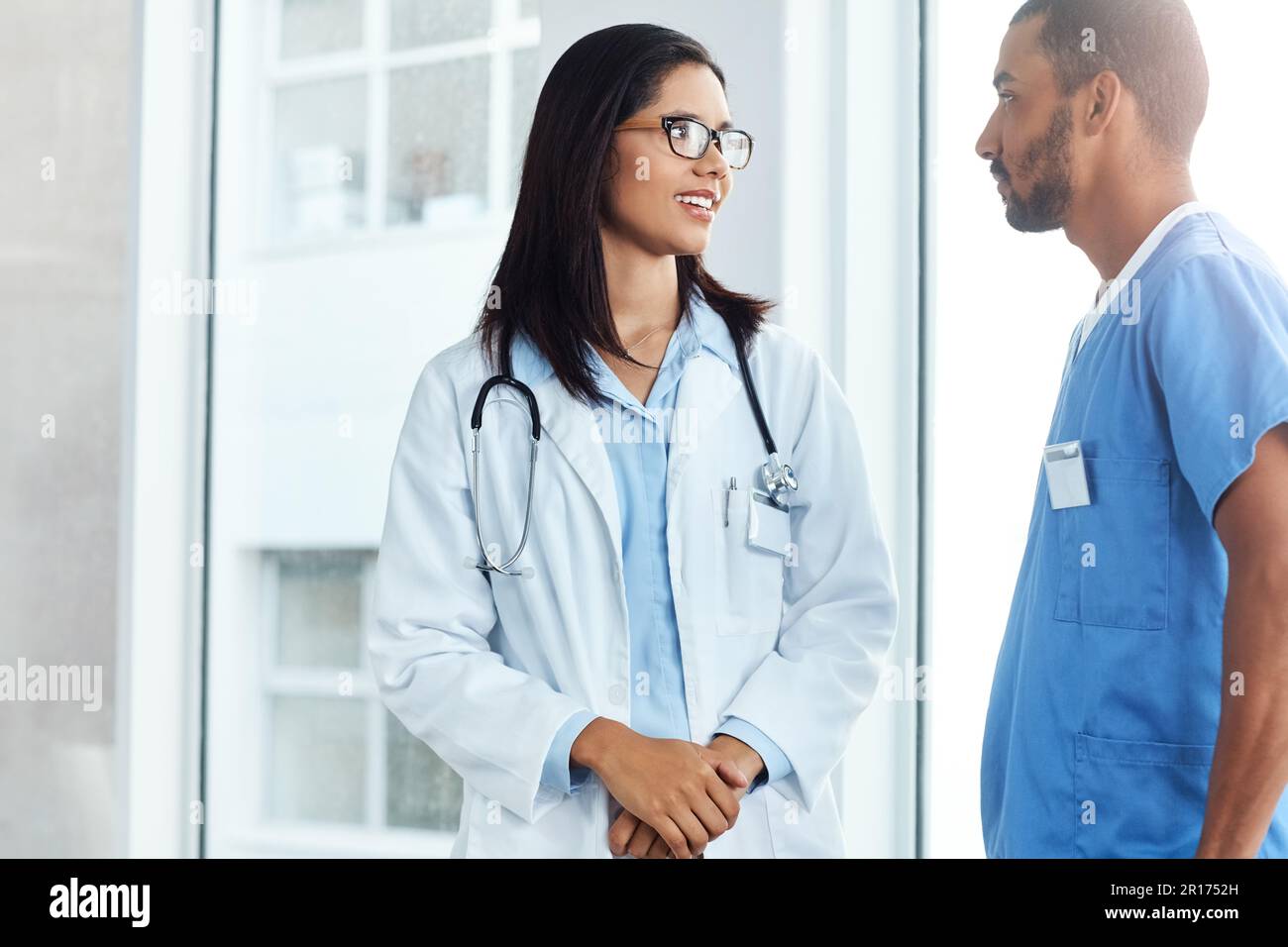Communication is key in patient care. two young doctors having a ...