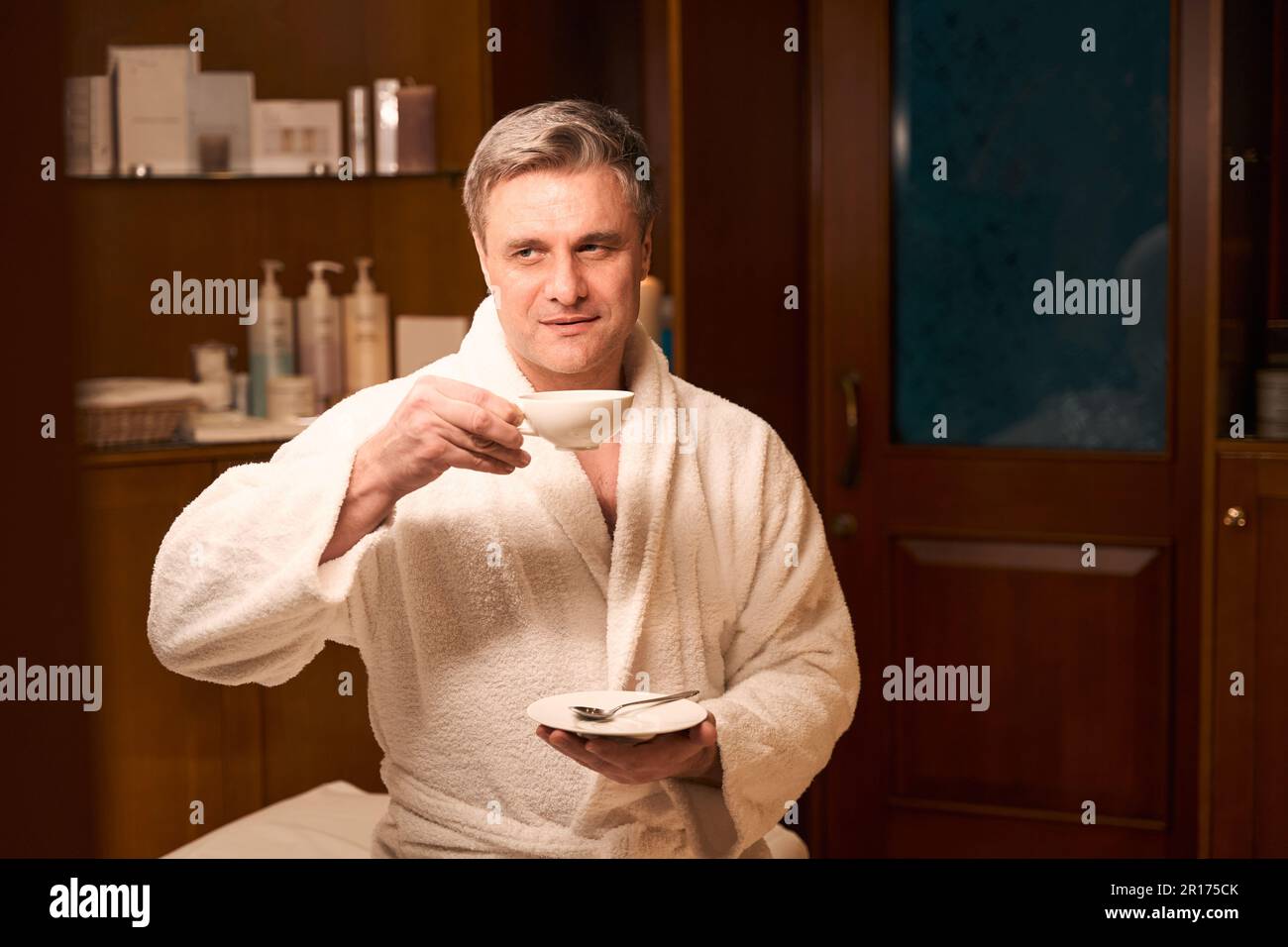 Serene wellness center customer sipping beverage before procedure Stock ...