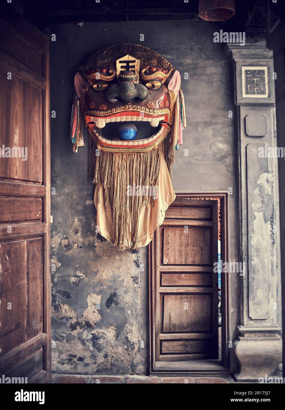 A vintage-style building with a unique facade and a decorative mask on ...