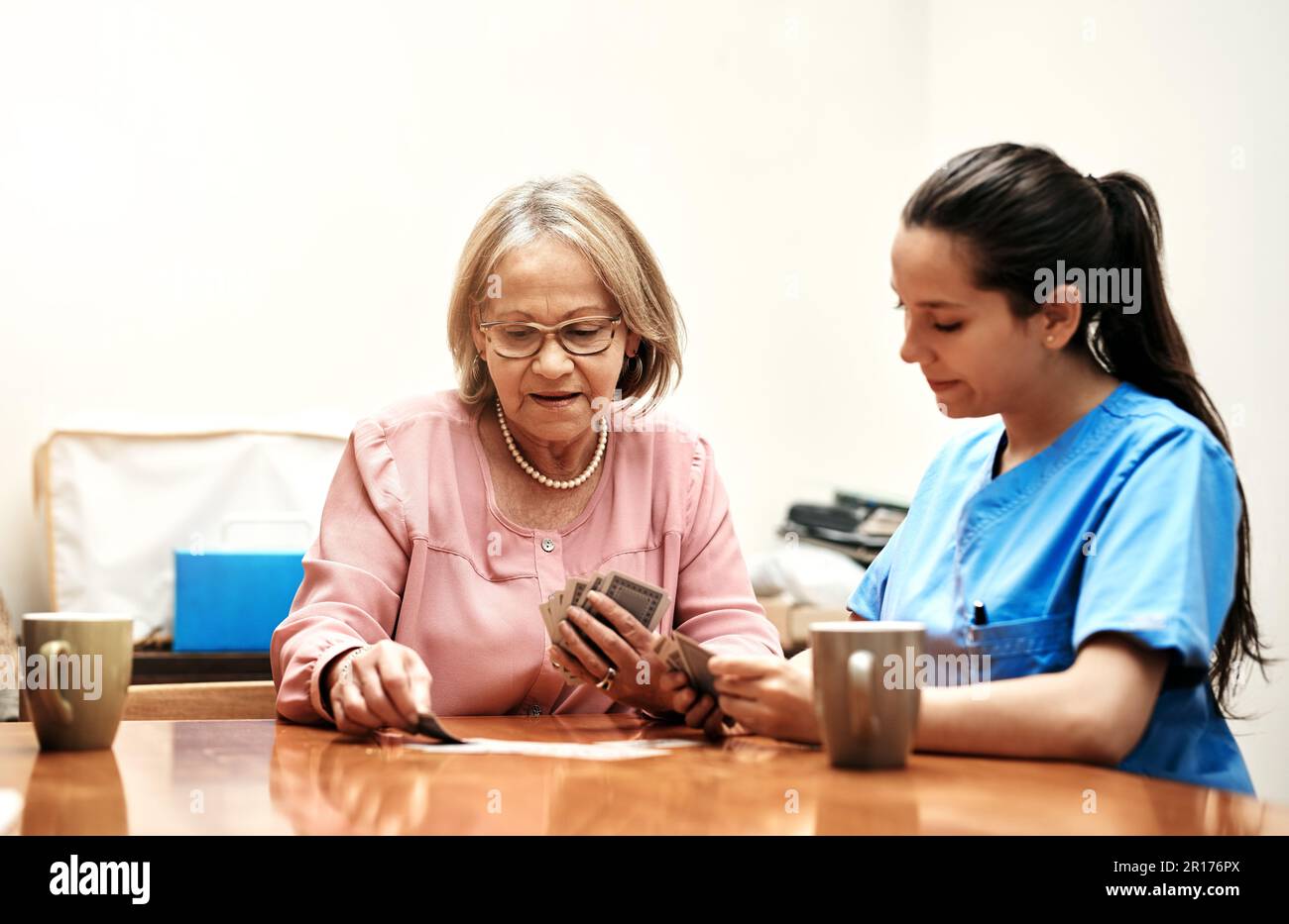 Youre playing against someone wiser...a senior woman playing cards with ...
