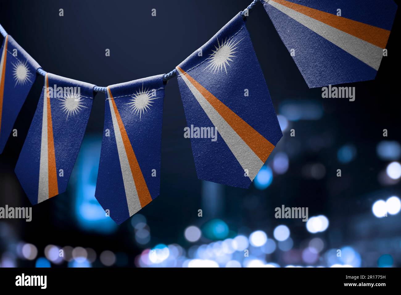 A garland of Marshall national flags on an abstract blurred background ...