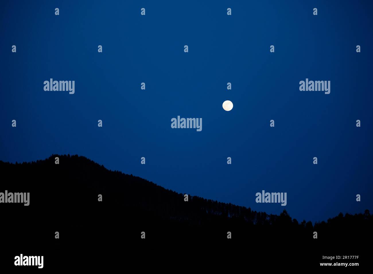 Moon floating in the night sky and mountains Stock Photo - Alamy