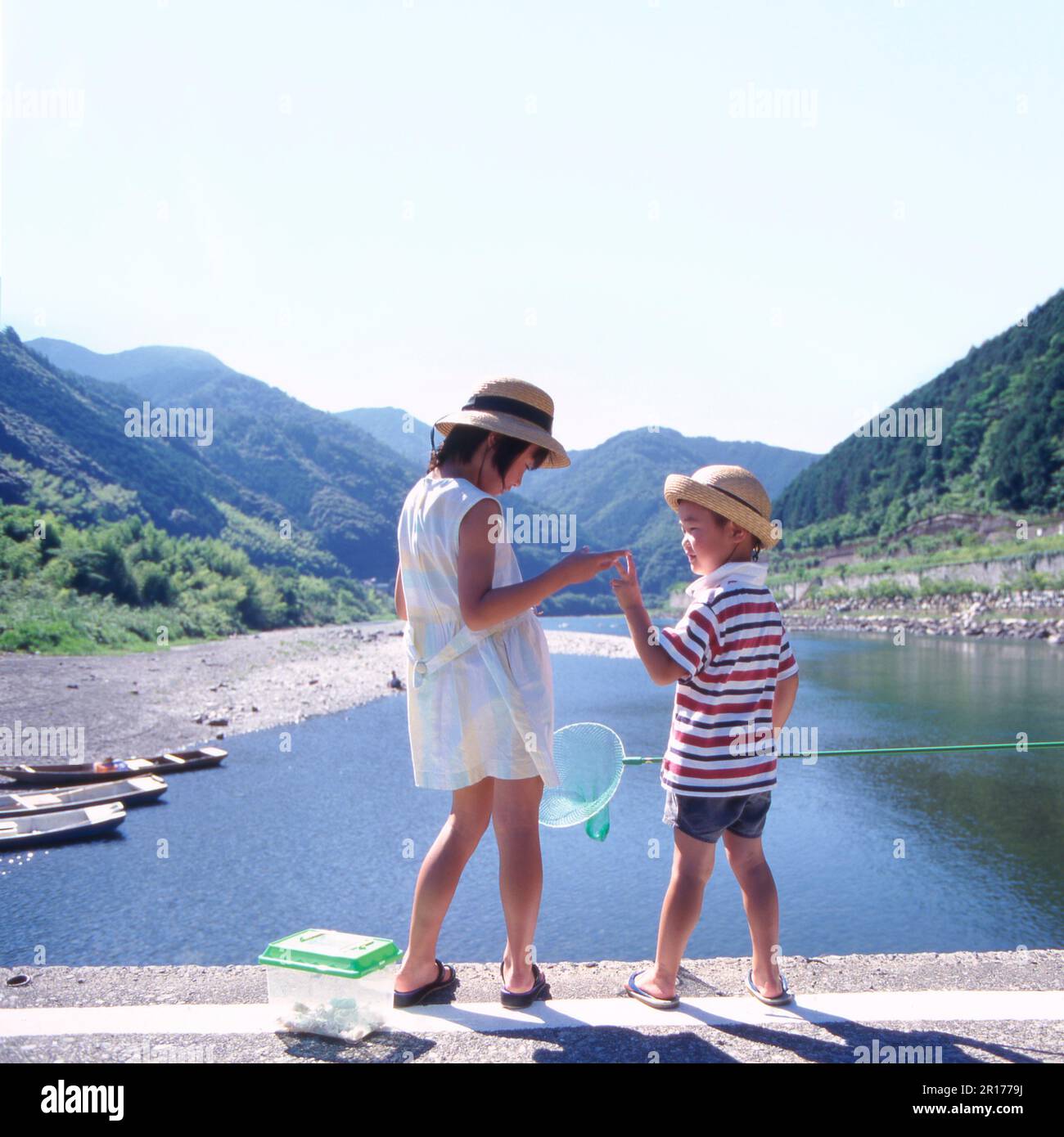 Japanese child playing in a river and holding an insect net Stock Photo ...