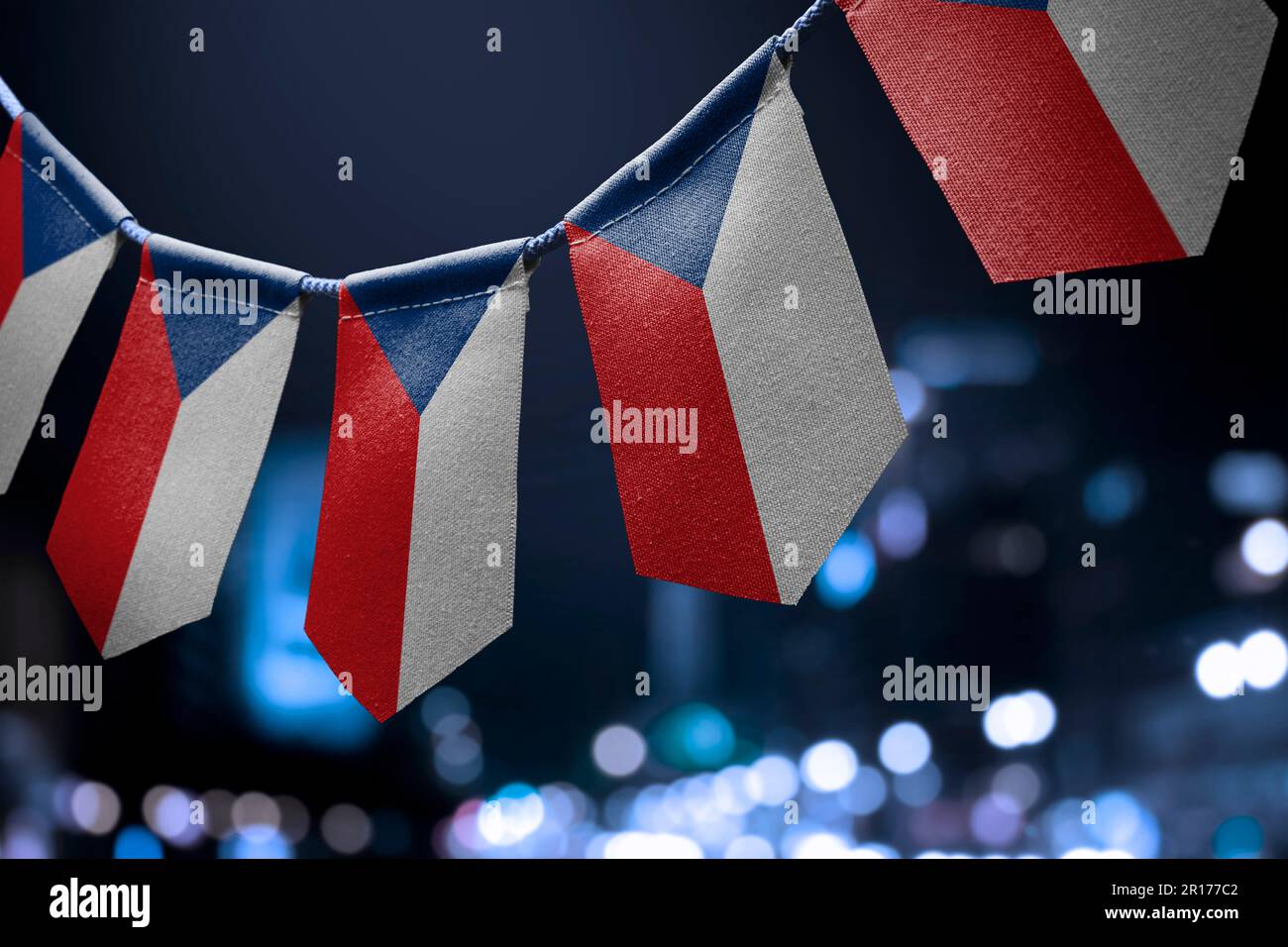 A garland of Czechia national flags on an abstract blurred background ...