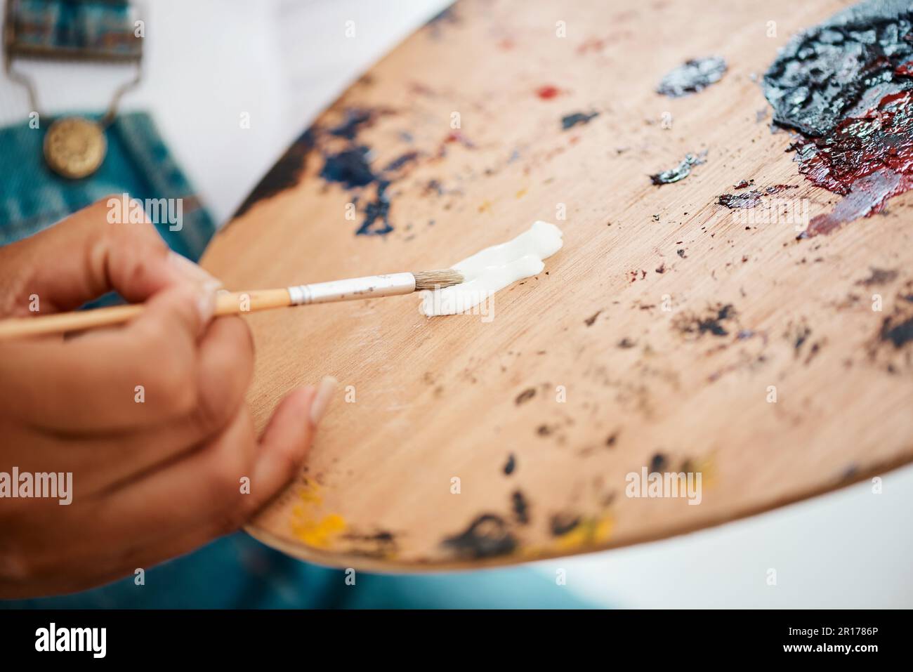 White is always the base paint. an unrecognizable artist dipping her ...