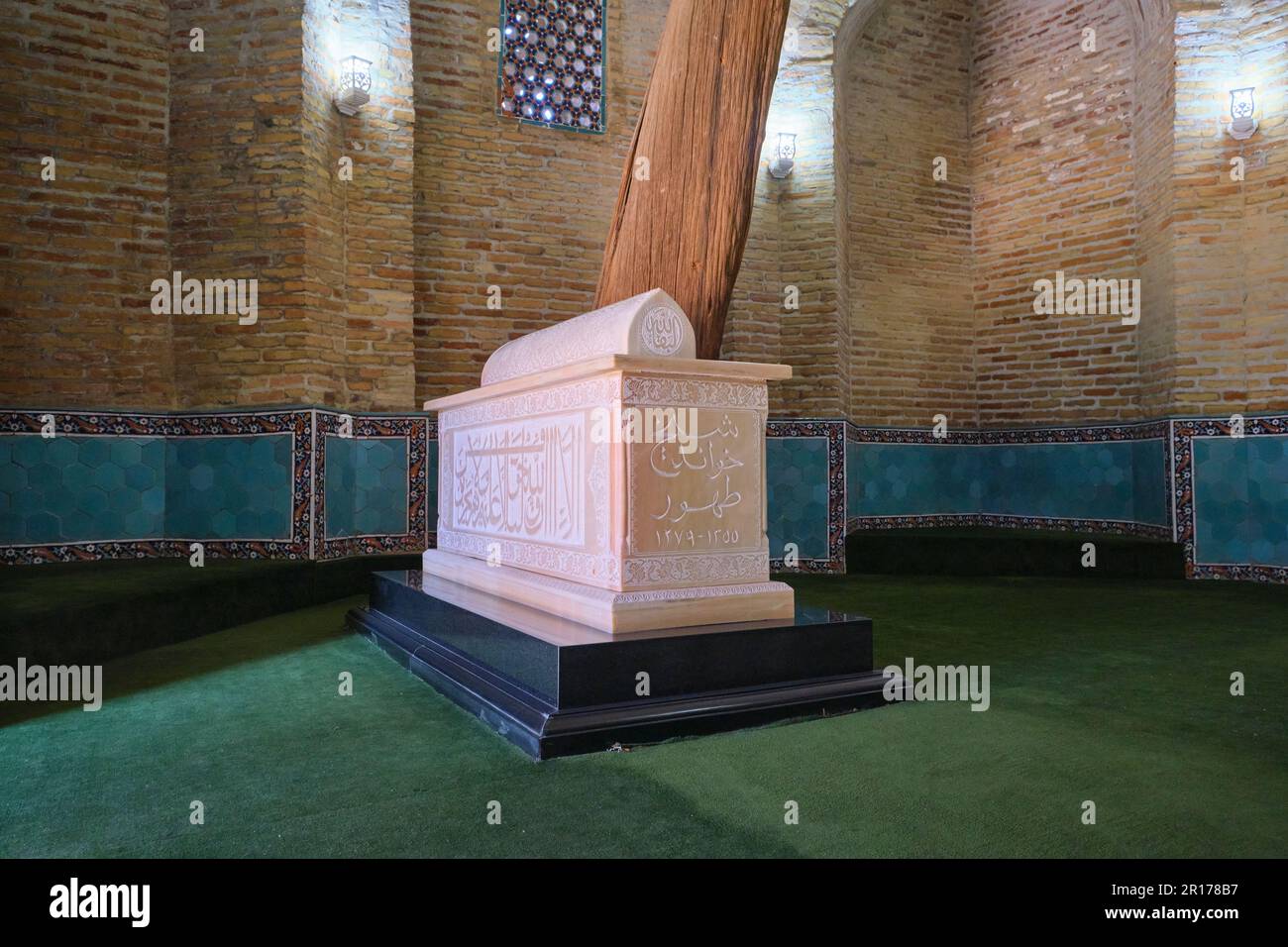 Interior white marble tomb with big wood tree branch. At the Sheikh ...