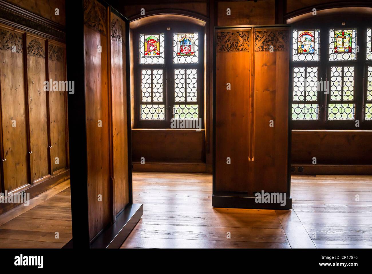 Room with wood panelling and carving and stained glass windows, Swiss ...