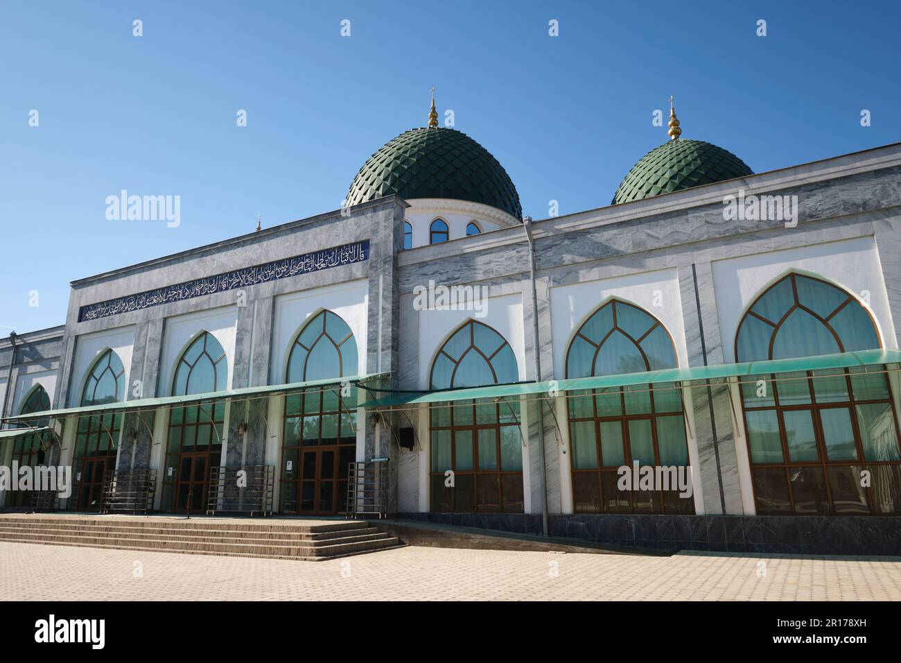 Exterior view of the front entrance facade with green dome. At the ...