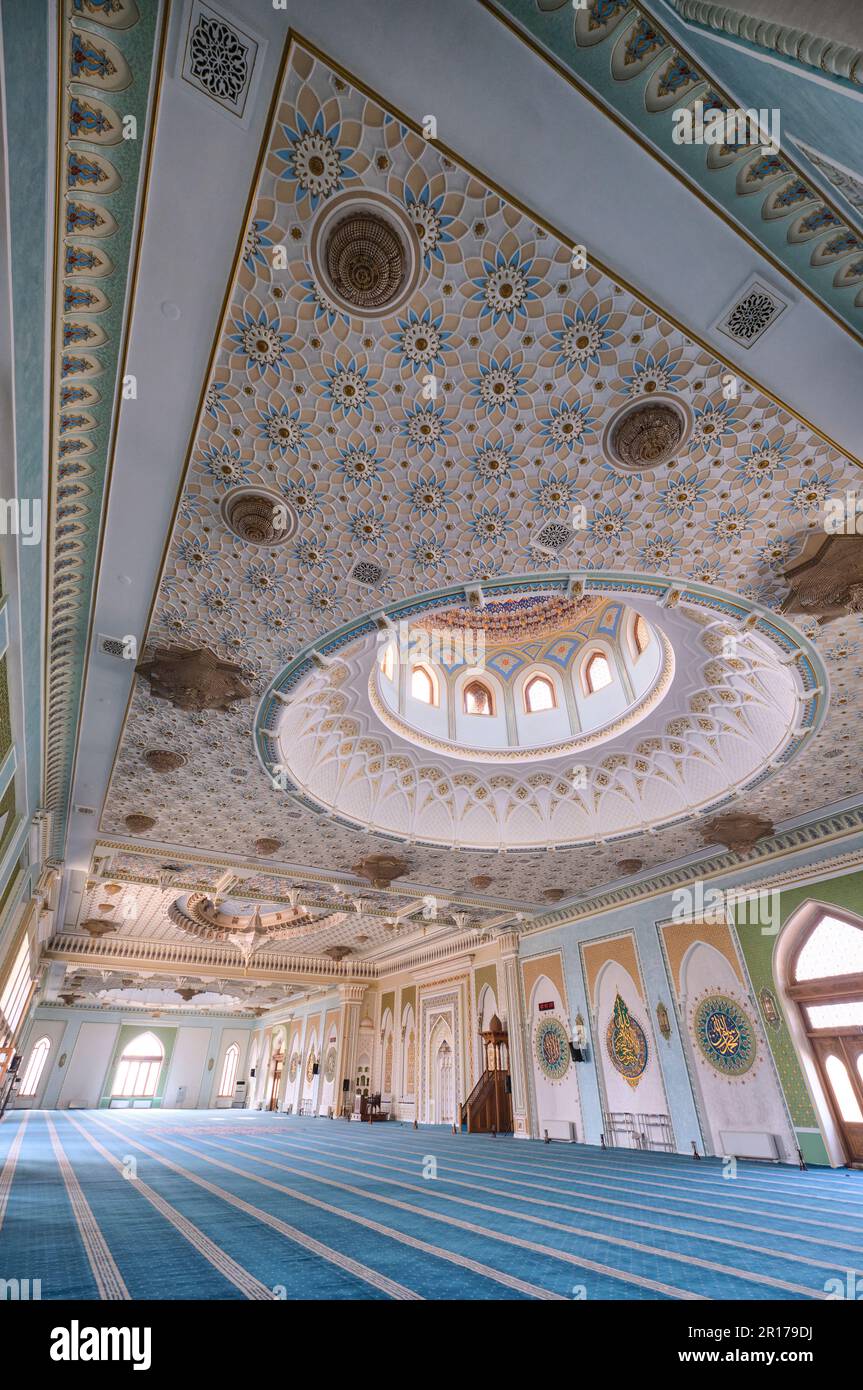 Interior view of the mosque, with white and gold finishes and a dome ...
