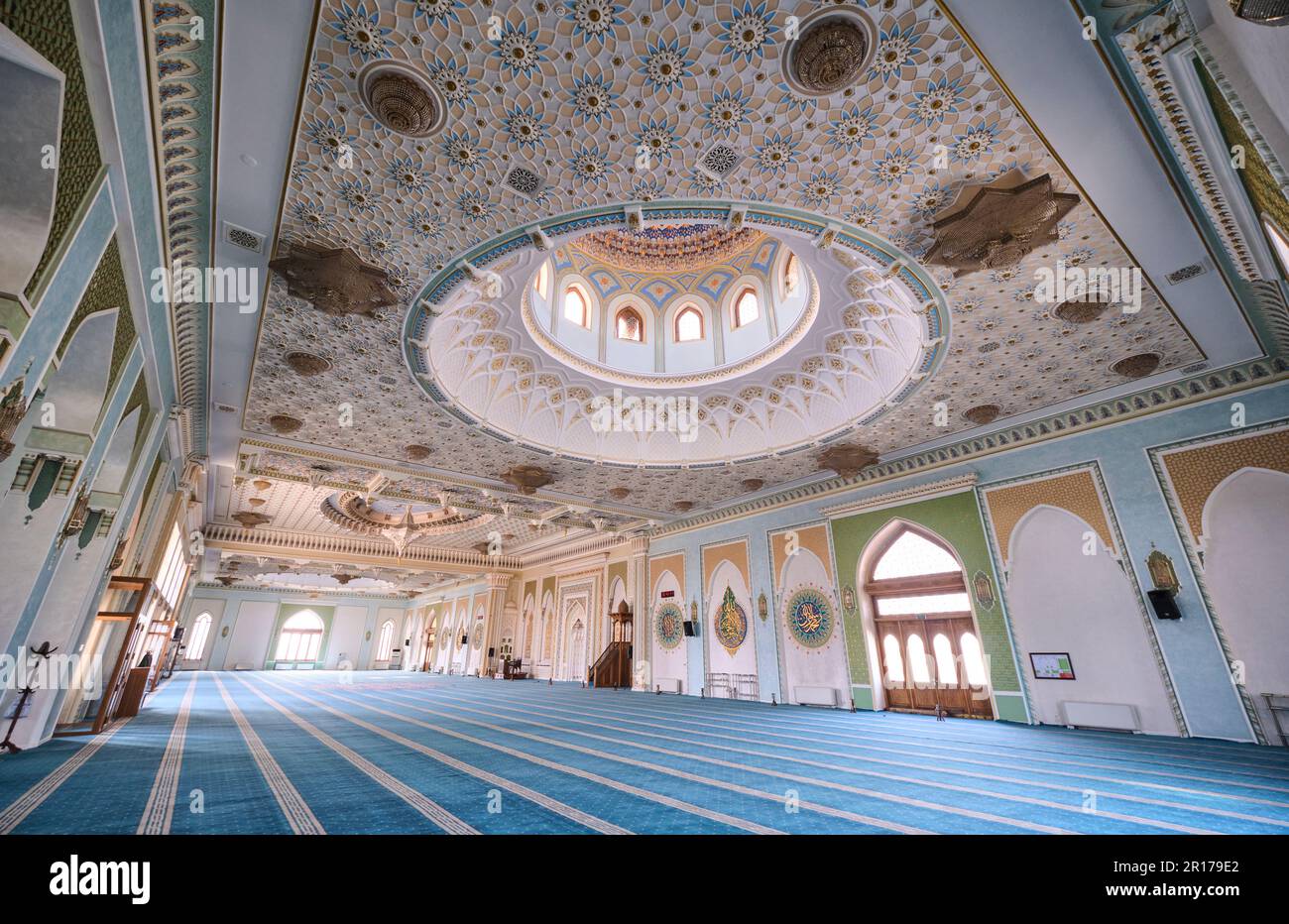 Interior view of the mosque, with white and gold finishes and a dome ...