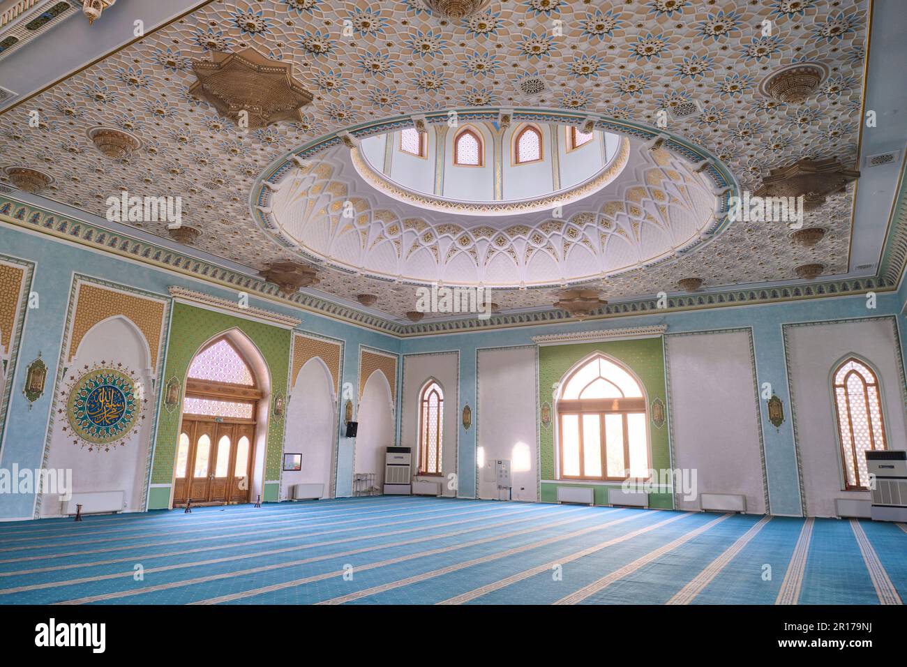Interior view of the mosque, with white and gold finishes and a dome ...