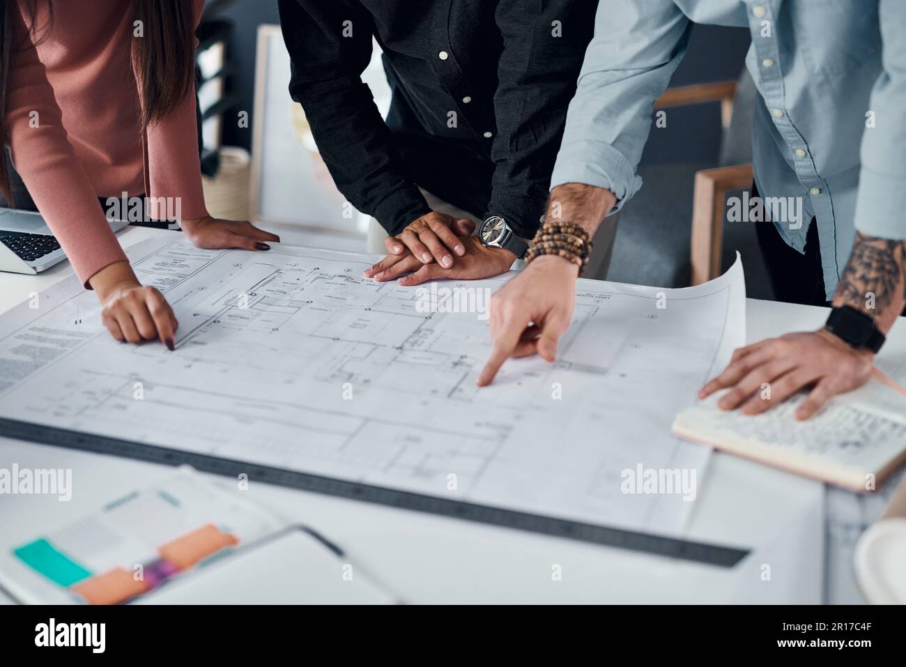 Its all part of the plan. three unrecognizable architects going over ...