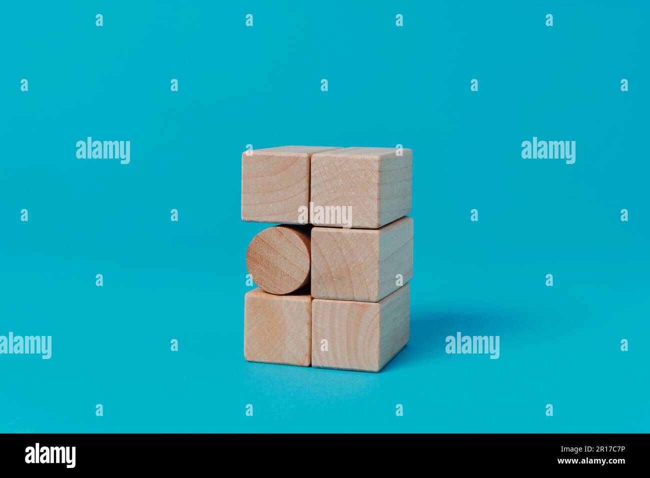 a cylindrical building block in a stack of rectangular building blocks ...