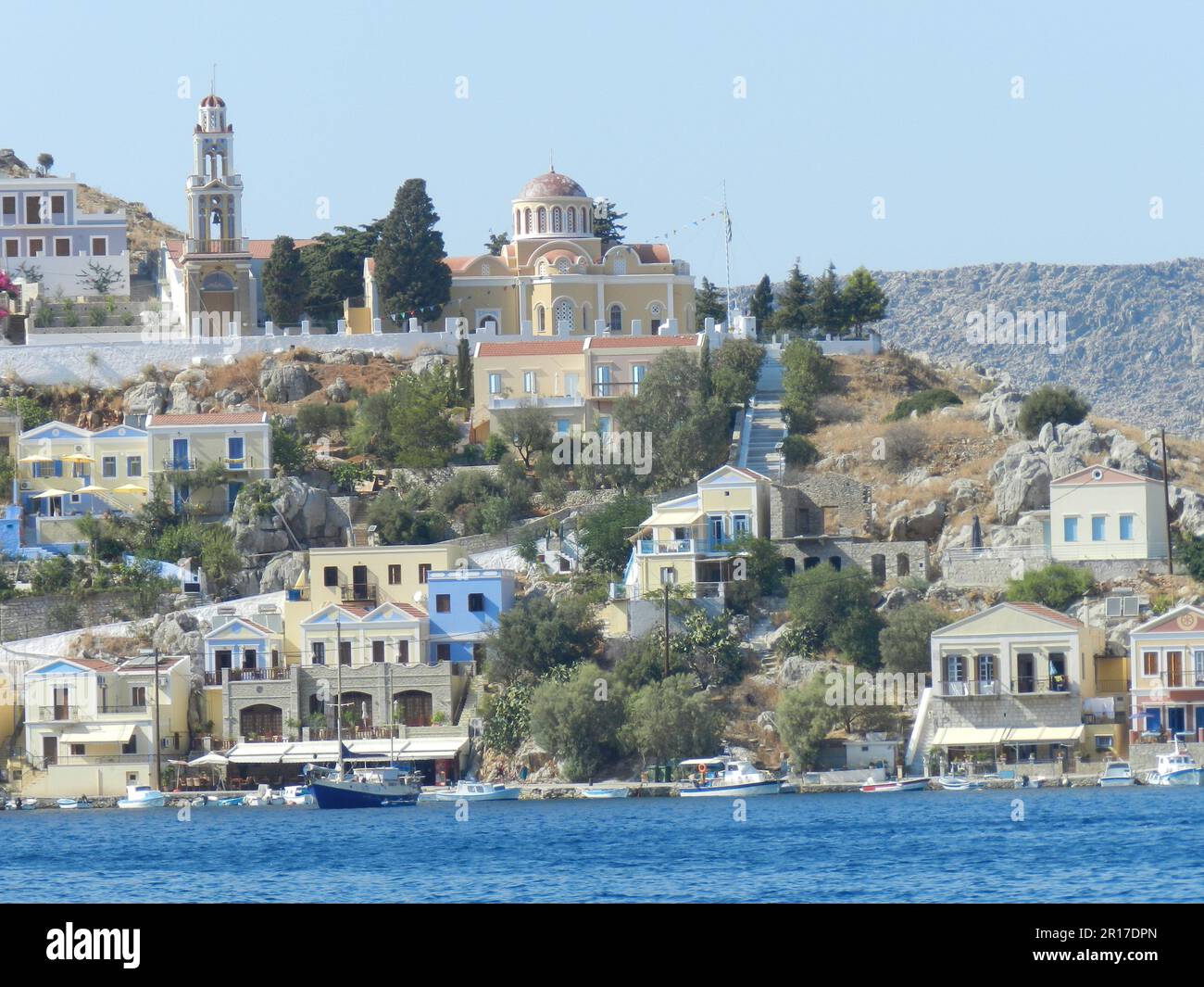 Greece, Island of Symi: classical houses with church on the hillside ...