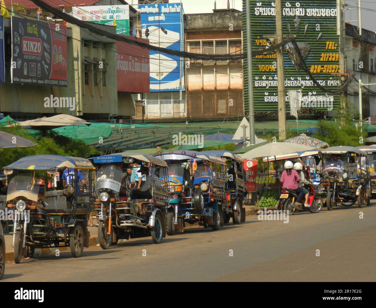 Laos, Vientiane: tuk-tuks lined up outside the bus station Stock Photo ...