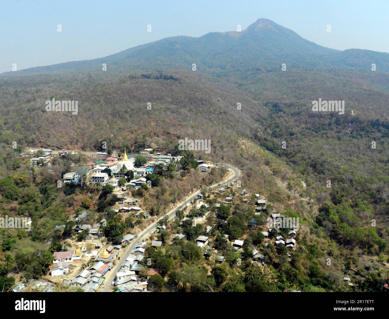 Myanmar, Bagan: view of the access road to Mount Popa, with village at ...