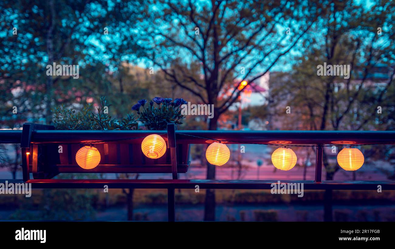 A lighted garland with solar lamps hung on the balustrade of the ...
