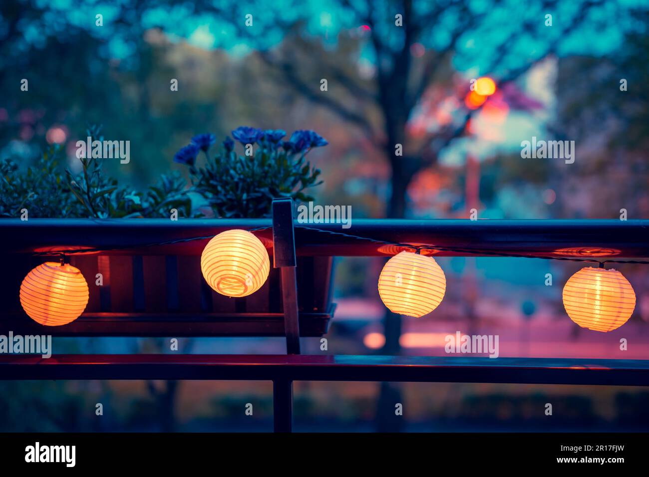A lighted garland with solar lamps hung on the balustrade of the ...