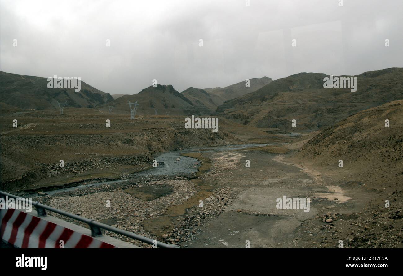 People's Republic of China, Tibet: barren river valley, approaching ...