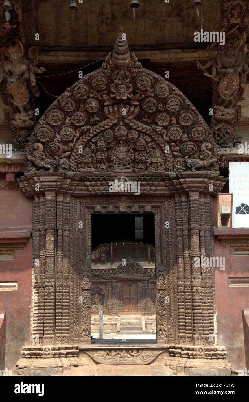 Nepal, Bhaktapur: carved wooden gate with nagas and guardian figures in ...