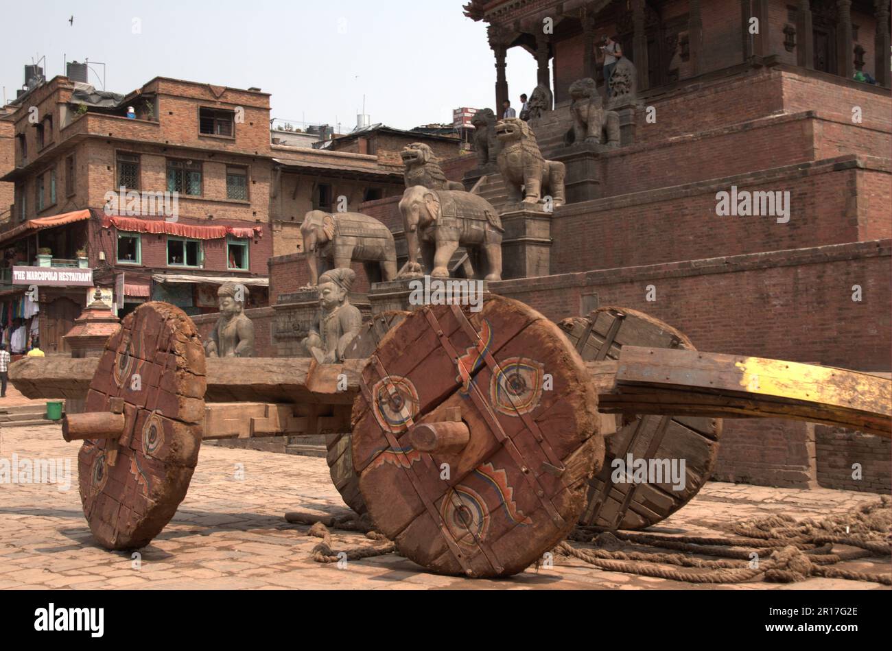 Nepal, Bhaktapur, Taumadhi Tol (Square): pair of giant wagon wheels ...