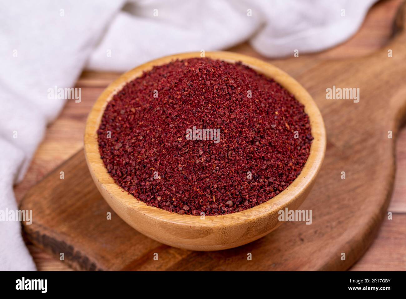 Sumac on wooden background. Dried ground red Sumac powder spices in ...