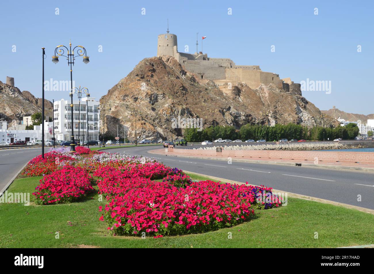 Oman, Muscat: Muttrah Fort overlooks flowerbeds on Al Corniche Stock ...