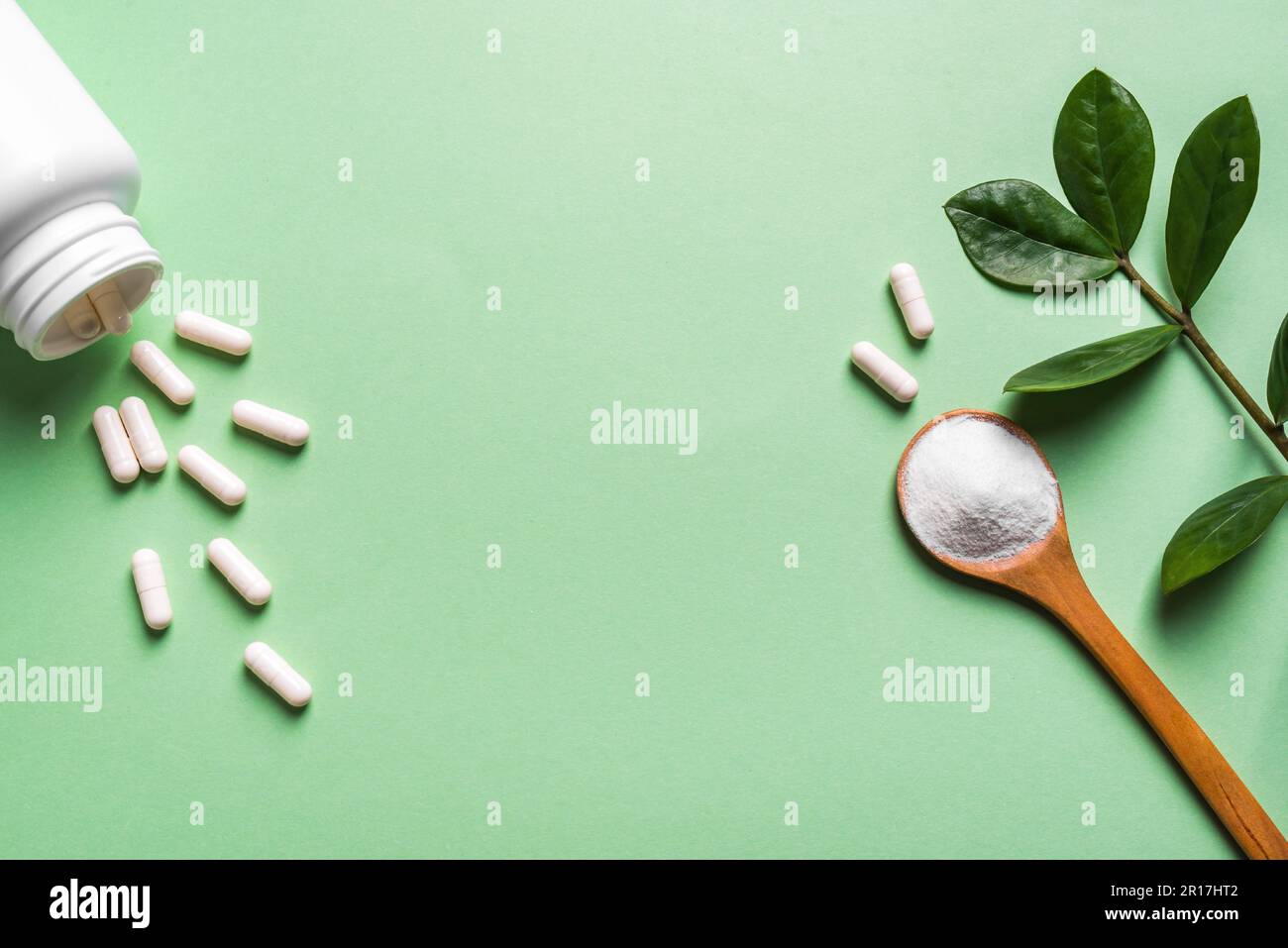 Collagen powder and capsules (pills) on green background. Vegan plant ...