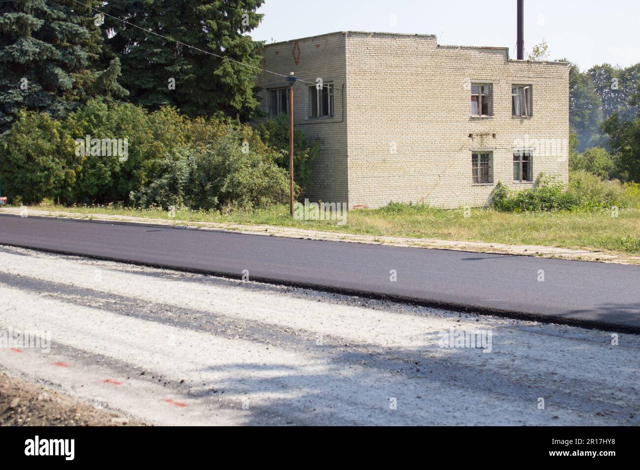 half of the road is covered with a new layer of asmalt through the ...