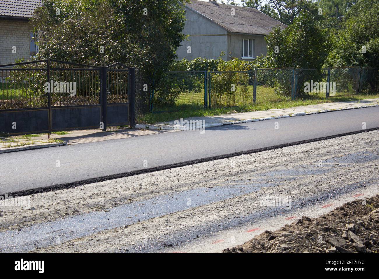 Through the village lay a new layer of asphalt Stock Photo - Alamy