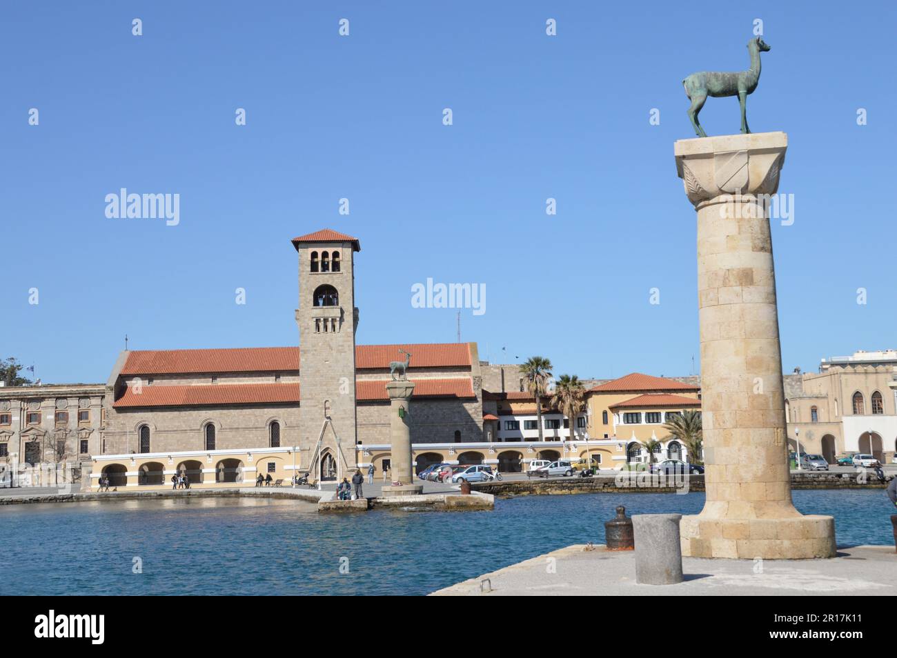 Greece, Island of Rhodes: entrance to Mandraki Harbour, with deer and ...