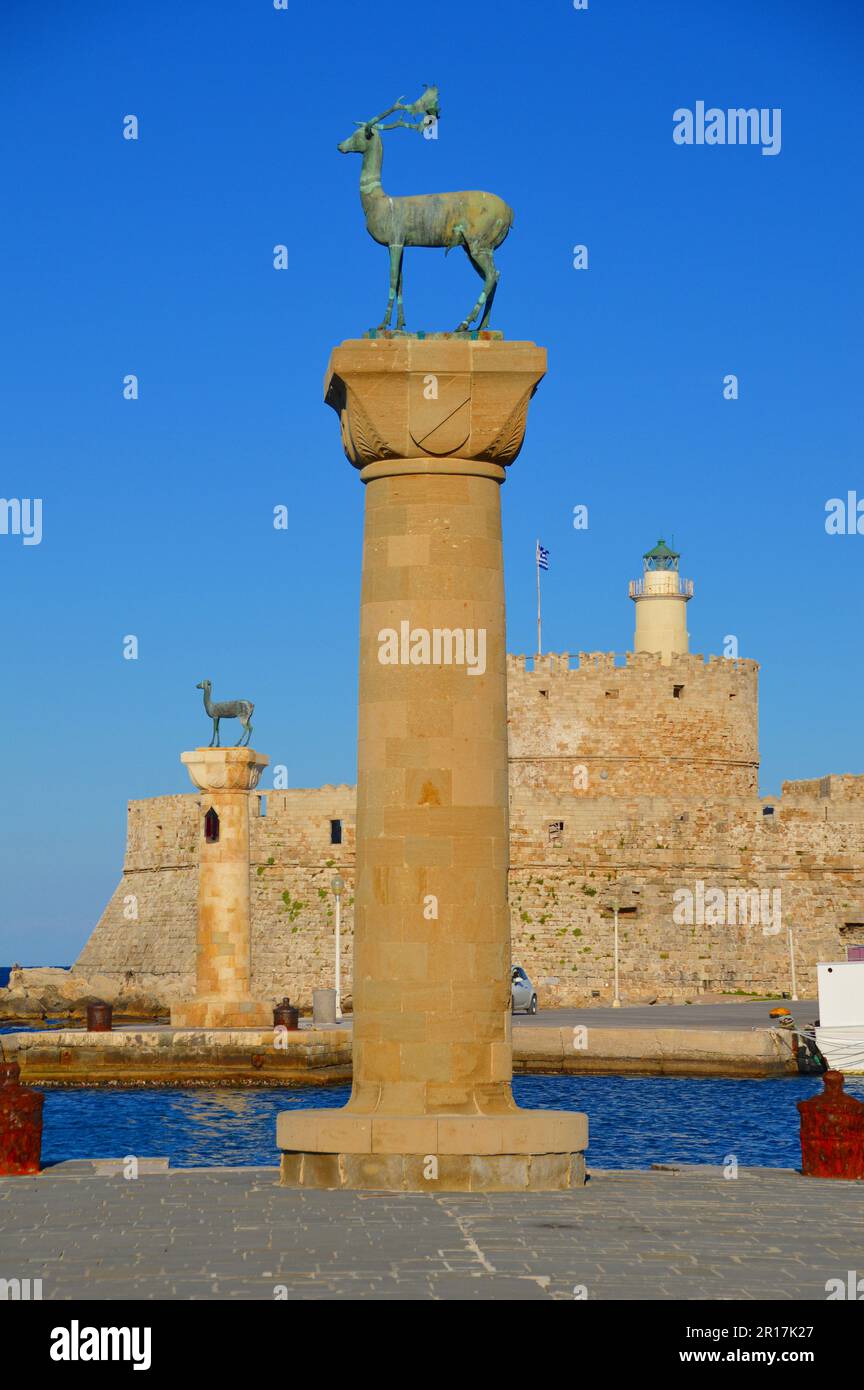 Greece, Island of Rhodes: entrance to Mandraki Harbour, with deer and ...