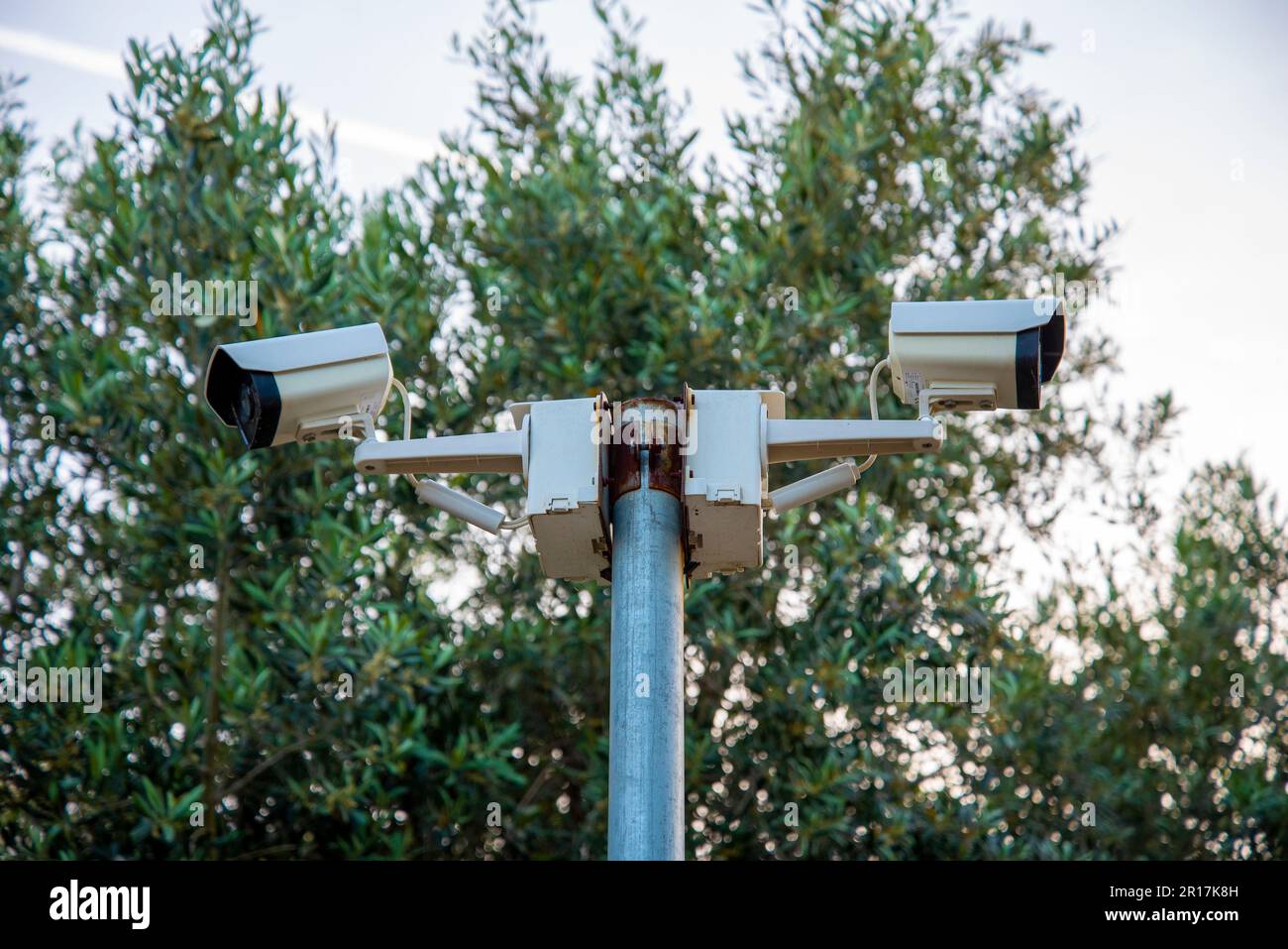 CC.TV. cameras on metal poles in public parks for the monitor ...