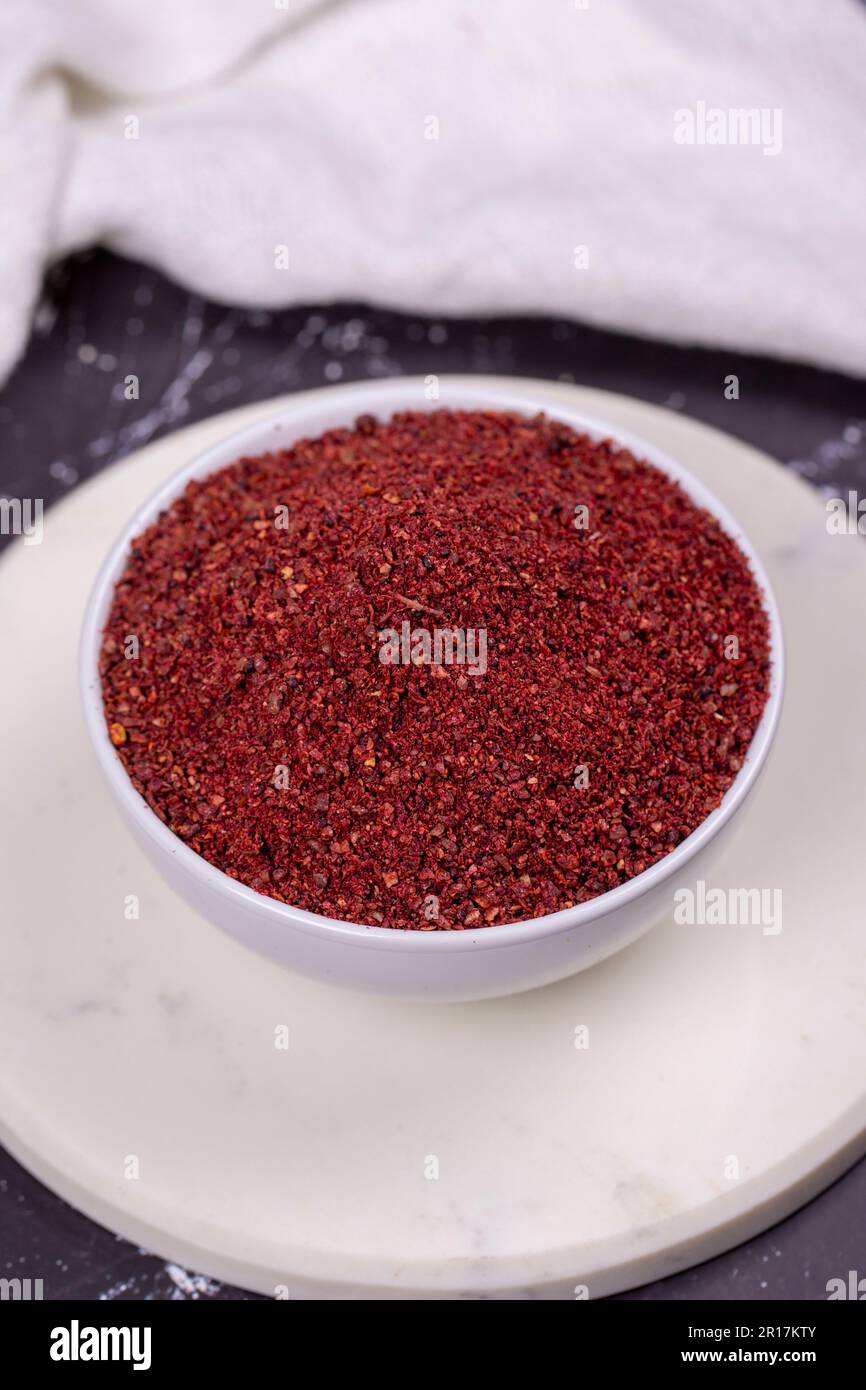 Sumac on dark background. Dried ground red Sumac powder spices in ...