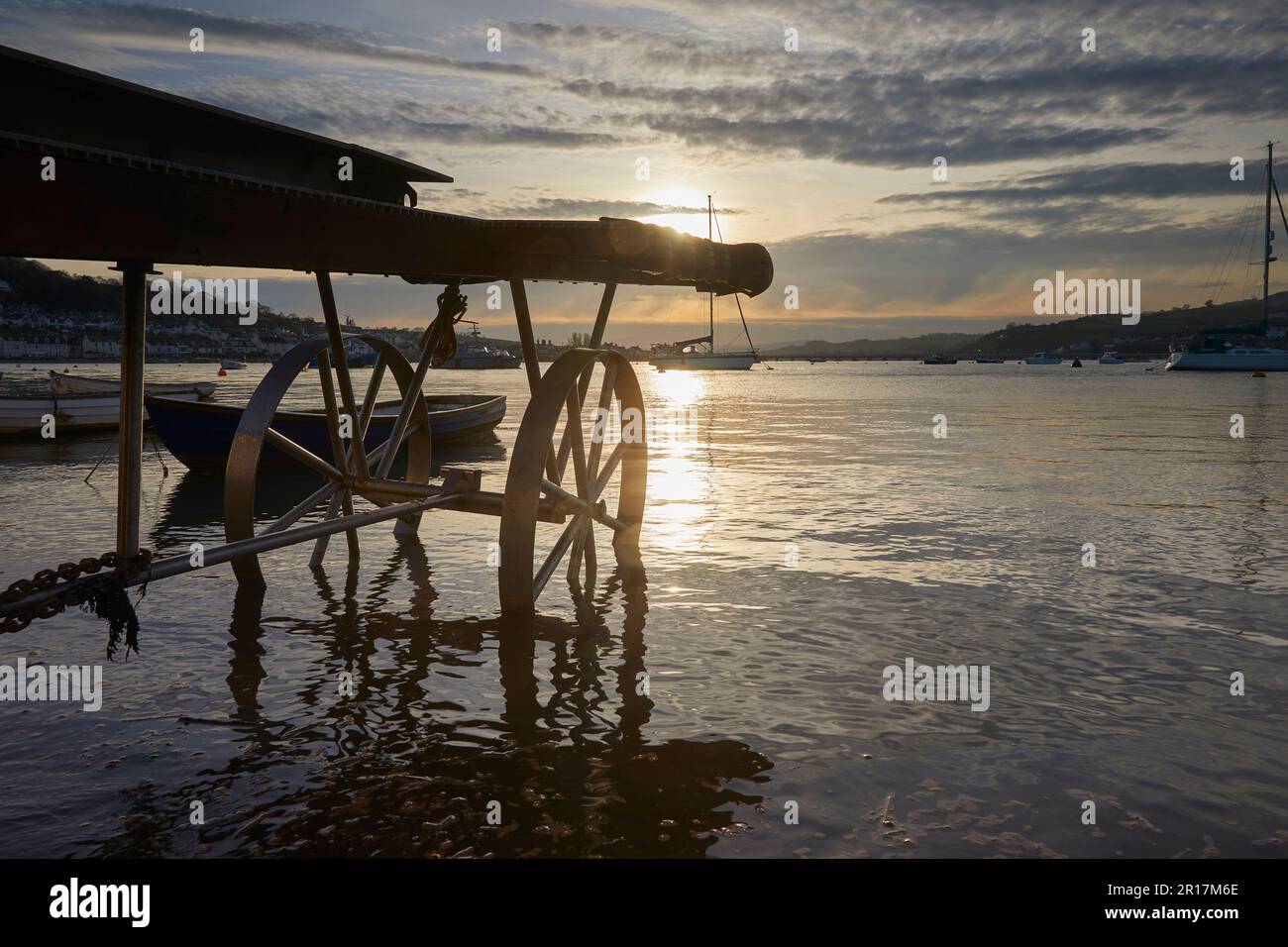 A sunset silhouette view of a harbourside scene on the estuary of the ...