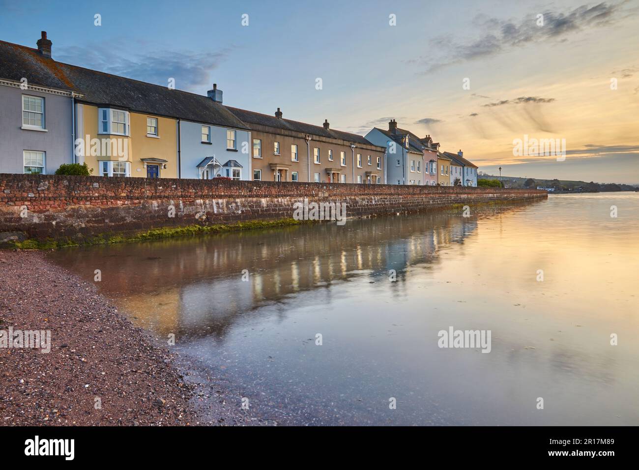 A calm dusk view of riverside houses, on the shore of the estuary of ...