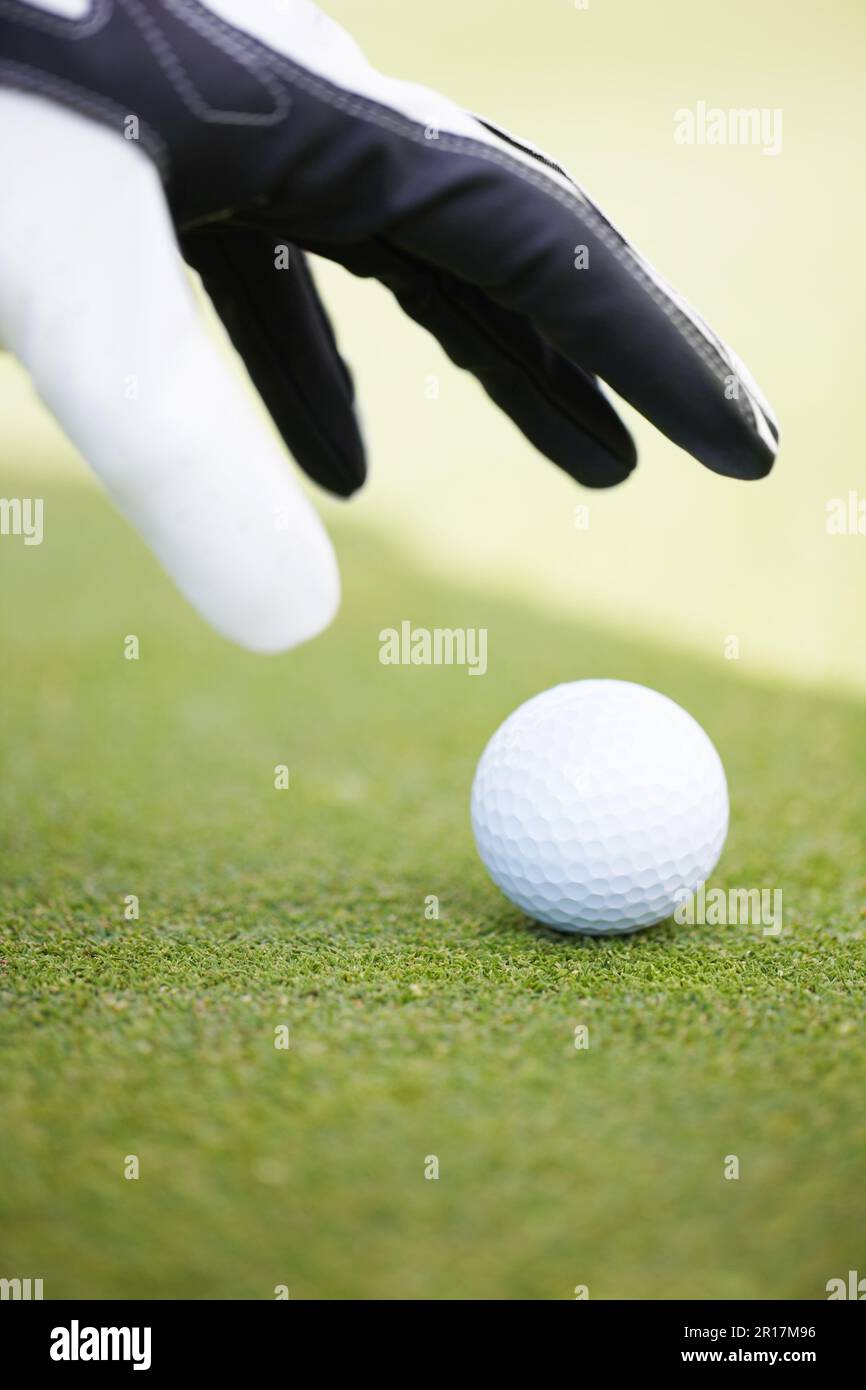 Lets get this ball rolling. Cropped image of a golfer placing the ball ...