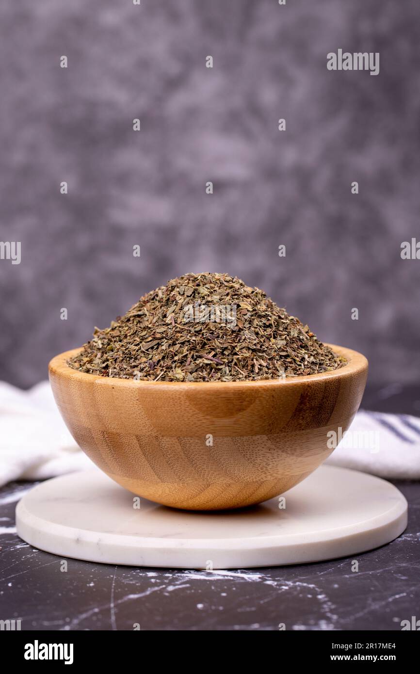 Dried crushed basil on dark background. Dried ground basil powder ...